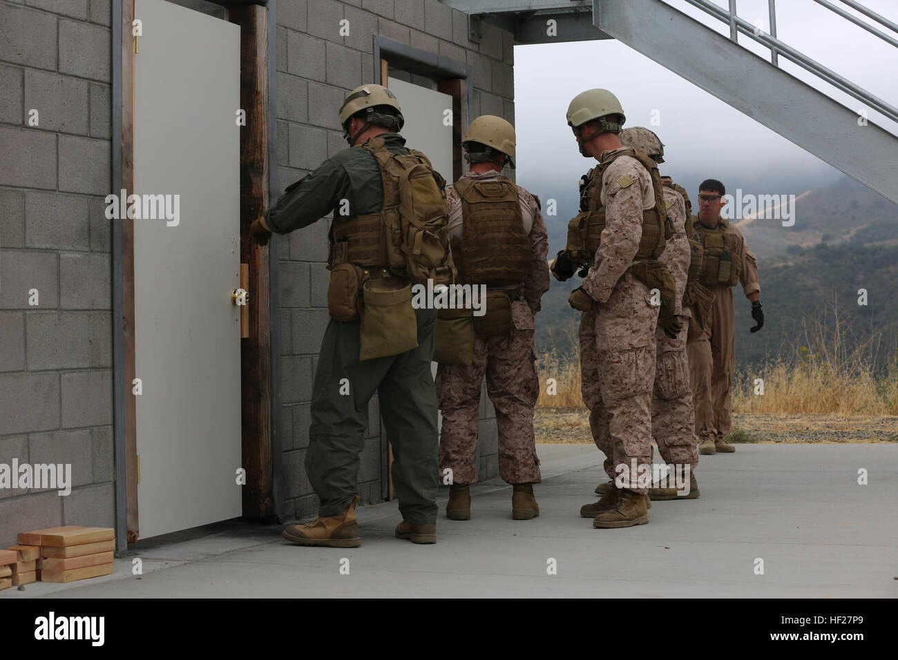 A Marine from 1st Reconnaissance Battalion prepares to place explosive ...