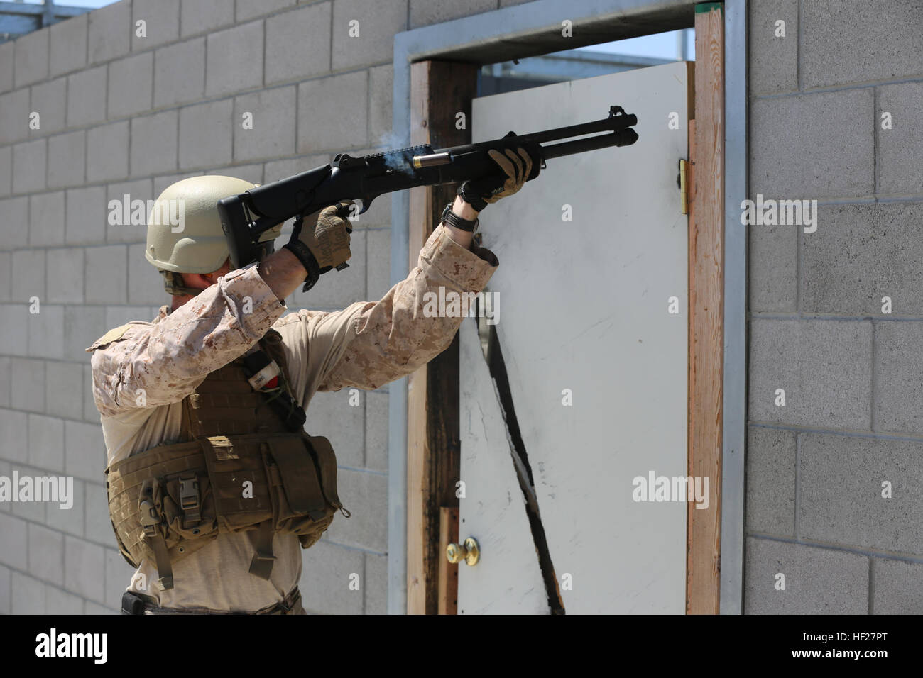 A Marine from 1st Reconnaissance Battalion fires breaching rounds into ...