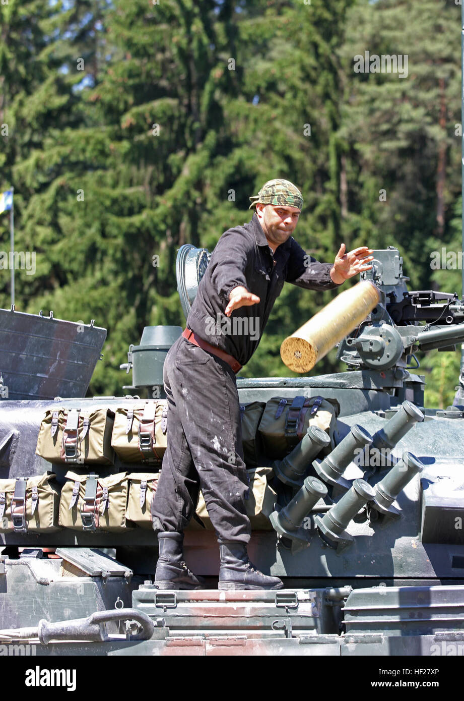 A crewmember from the Romanian army's 284th Tank Battalion unloads ...
