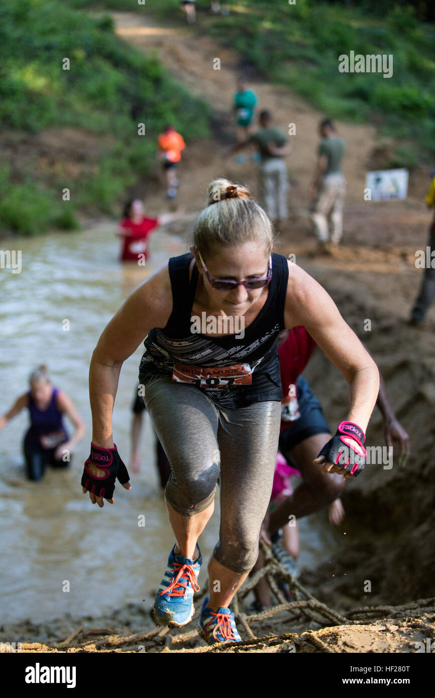 Participants navigate mud and water obstacles during the annual Run ...