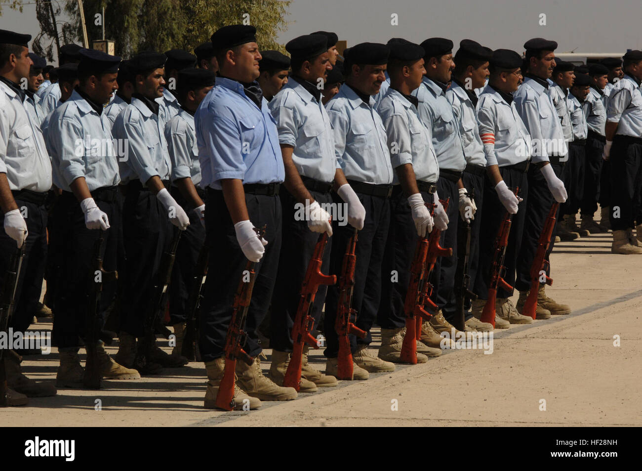 Iraqi police graduates stand in formation waiting for their graduation ...