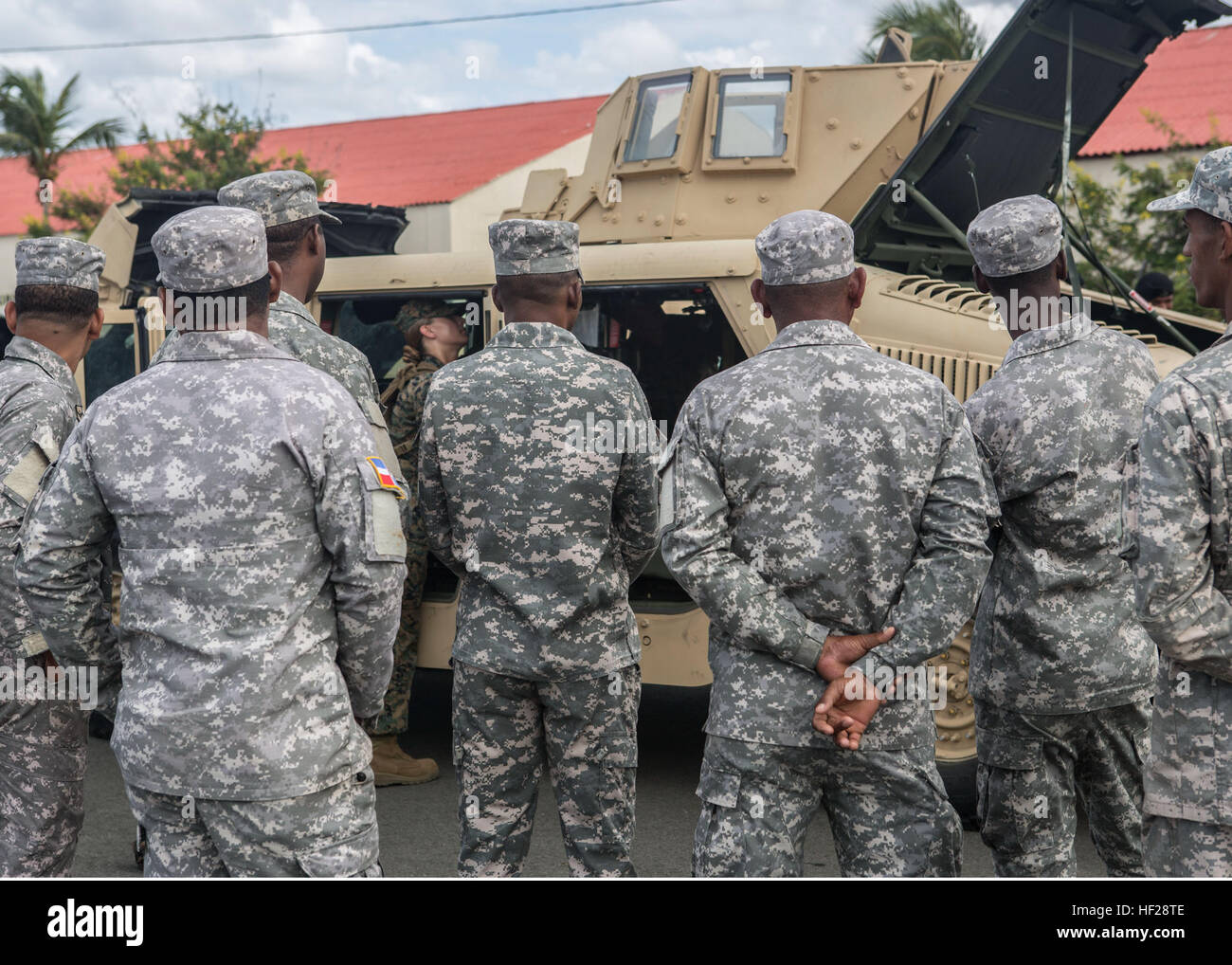 Military personnel from the Dominican Republic watch a vehicle search ...
