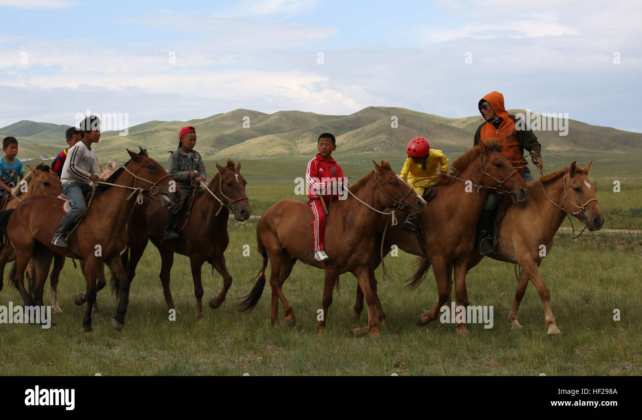 Mongolian children ride their horses before completing a 22-km race ...