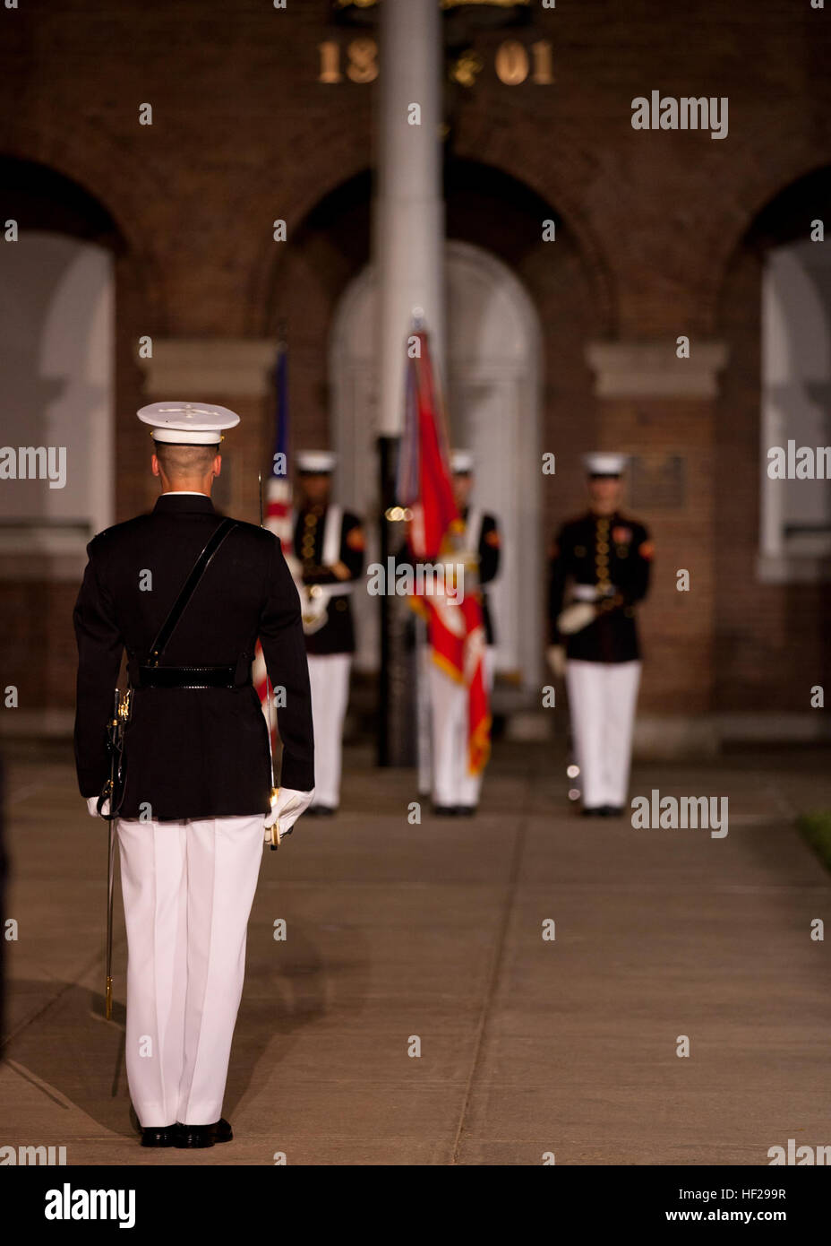 A U.S. Marine stands at attention at center walk during an Evening ...
