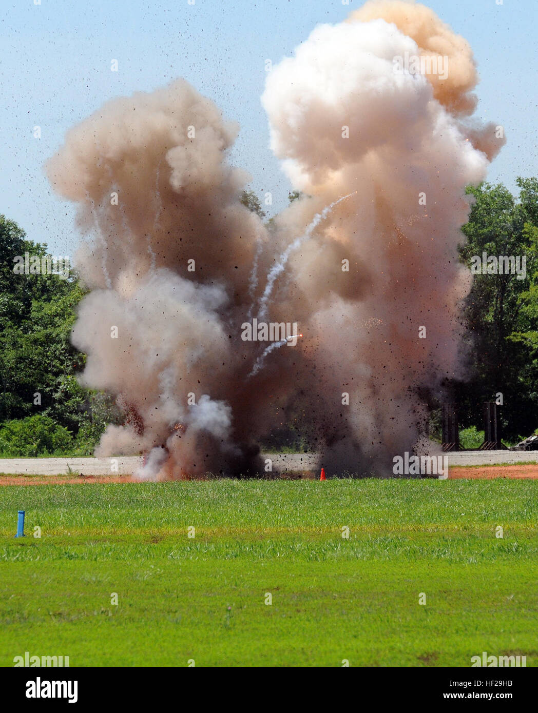 Debris fly higher than the tops of trees during an explosives ...