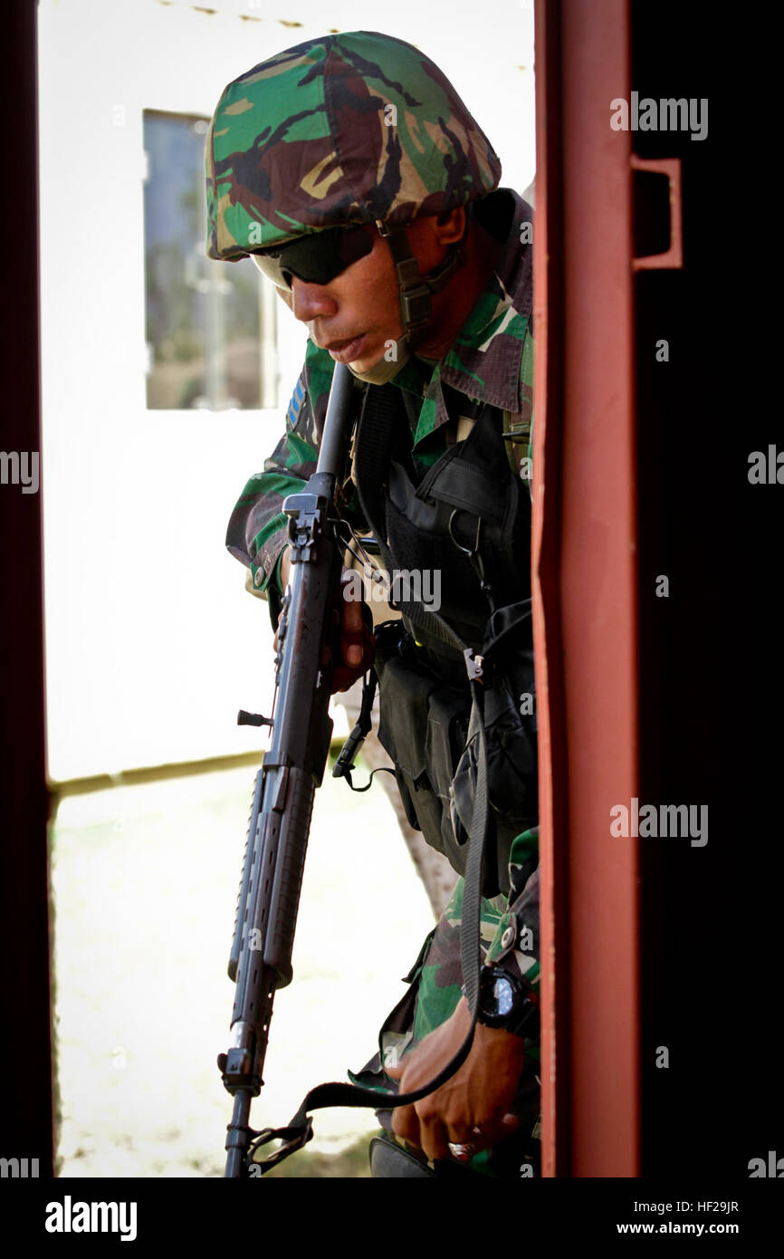 An Indonesian Marine prepares to conduct a house sweep during Military ...