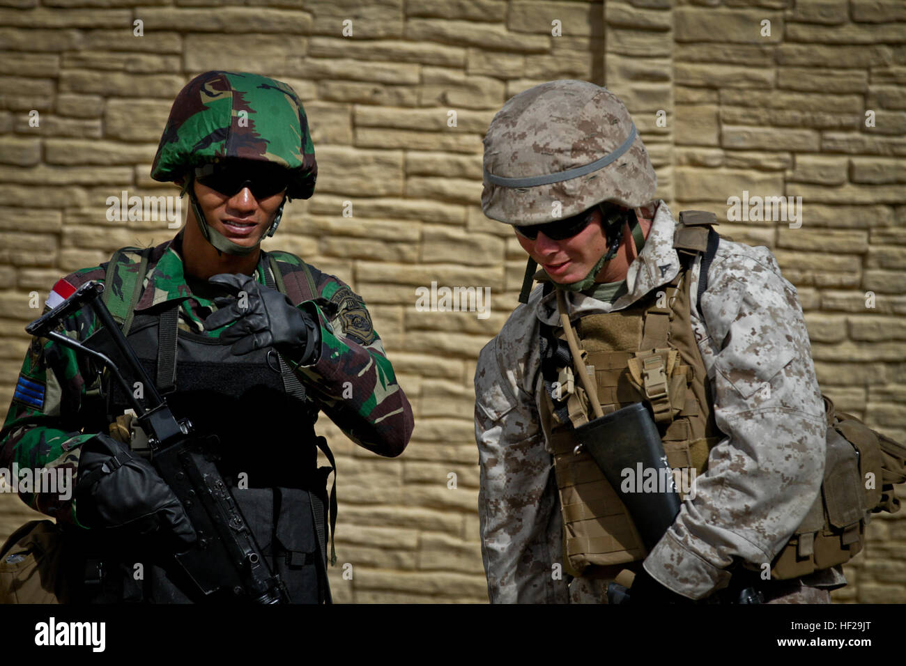 A U.S. Marine and Indonesian Marine discuss their different approaches ...
