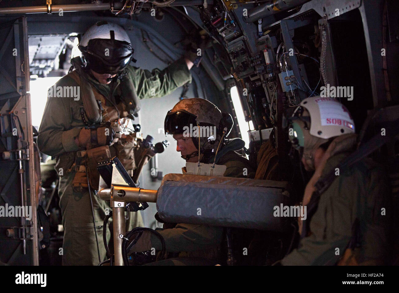 Corporal Eric Cotter (center), MV-22 crew chief with Marine Operational ...