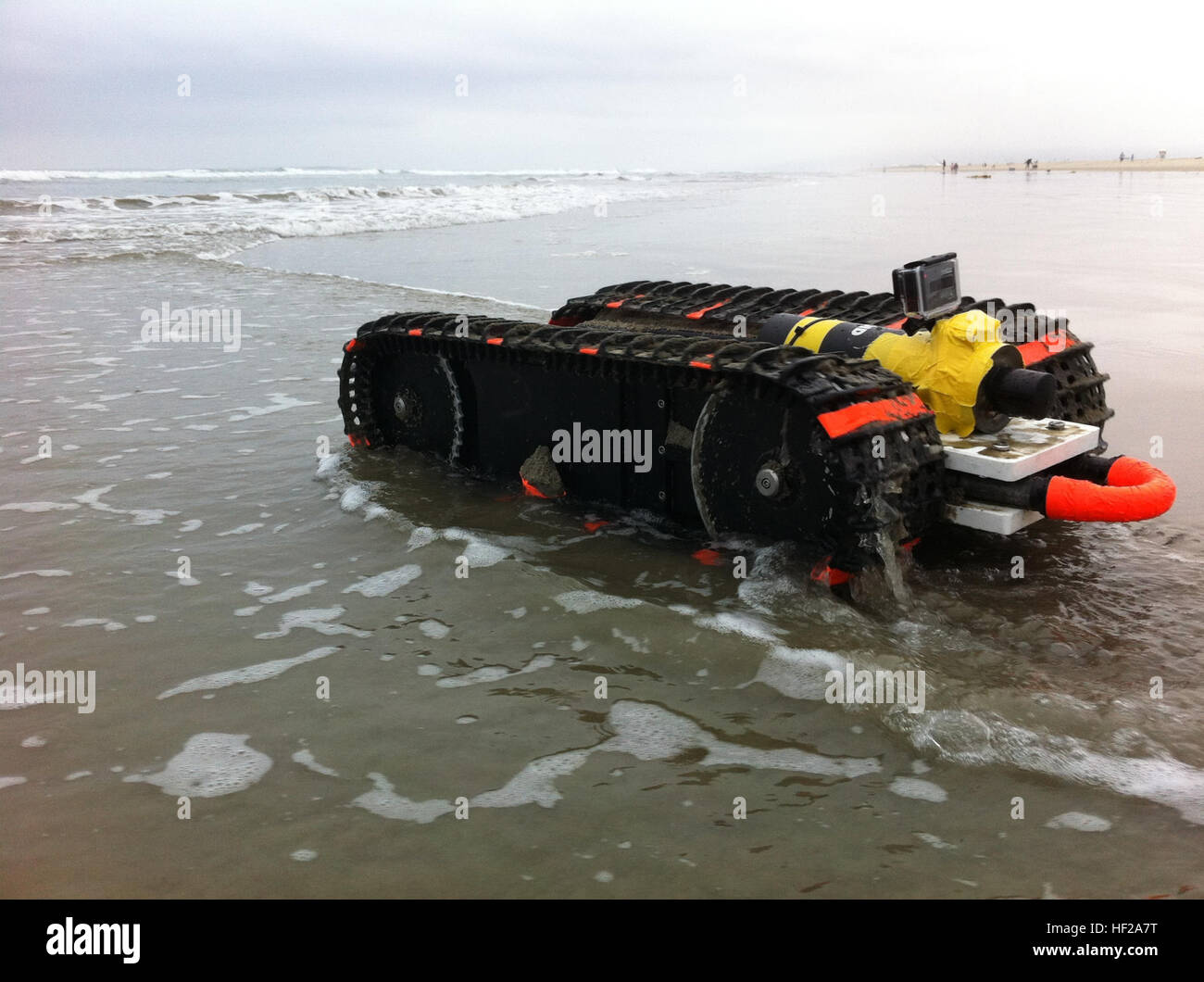 An autonomous underwater vehicle maneuvers into the surf during a ...