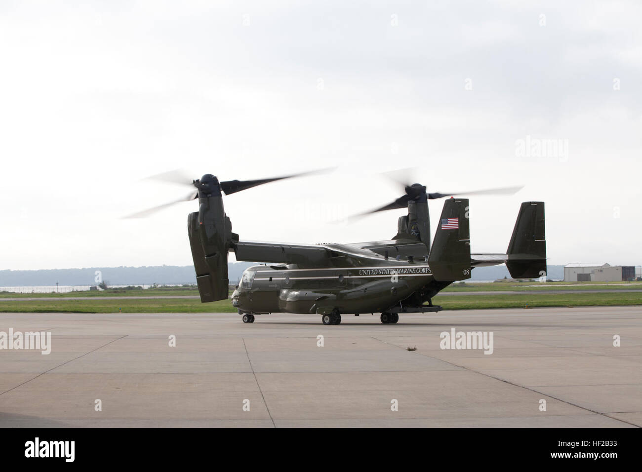 A U.S. Marine Corps MV-22 Osprey tilt-rotor aircraft sits on the flight ...