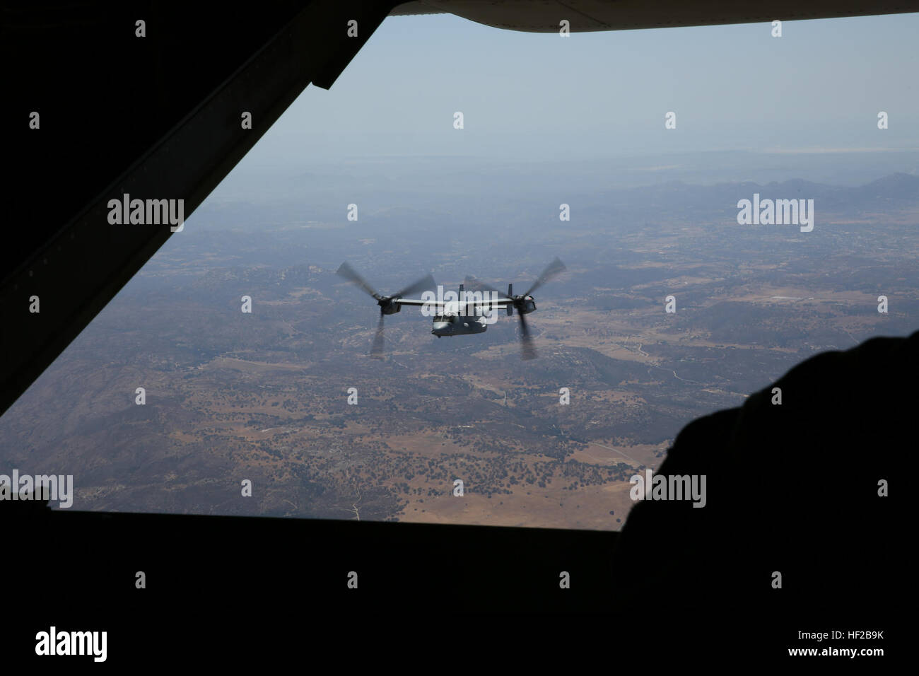 An MV-22B Osprey with Marine Medium Tiltrotor Squadron (VMM) 166 flies ...