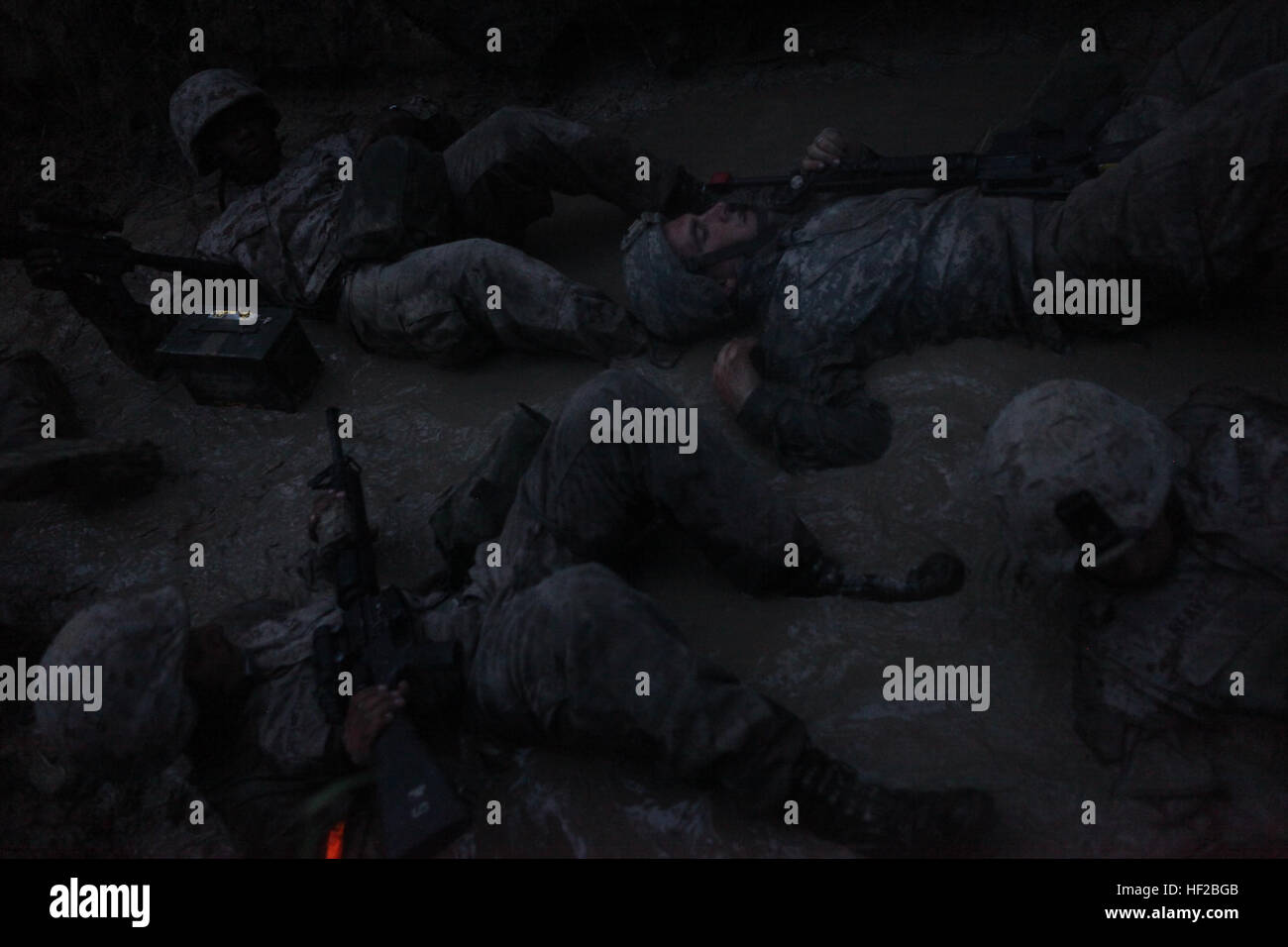 Marines and soldiers participating in the sapper leader's course crawl ...