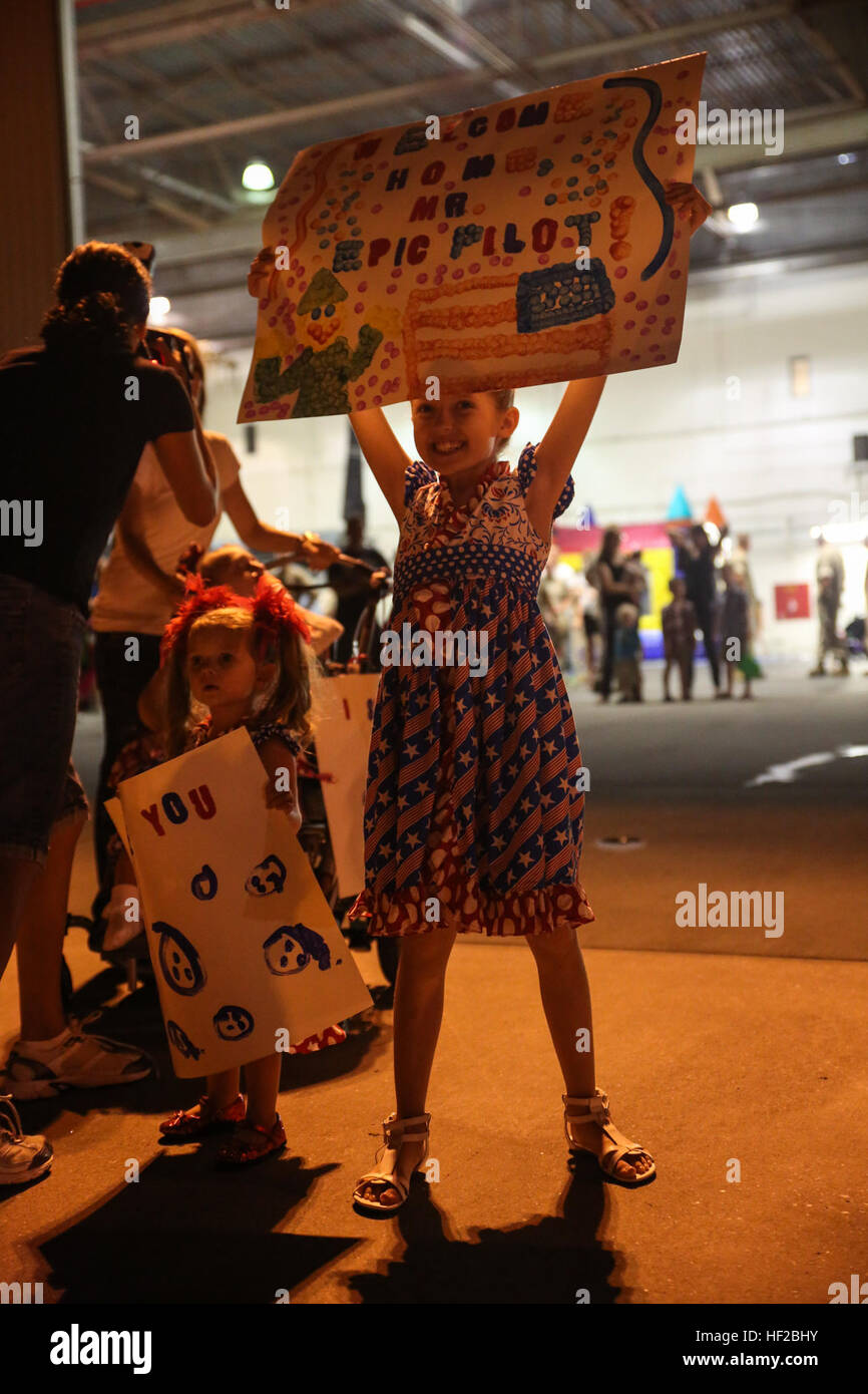 Sade Frame, the daughter of Capt. Nathan Frame, holds a sign with her ...