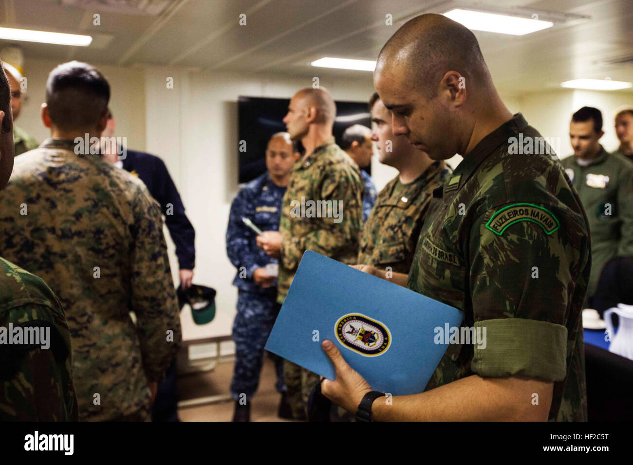 A Marine with the Brazilian Navy reviews his welcome packet aboard the ...