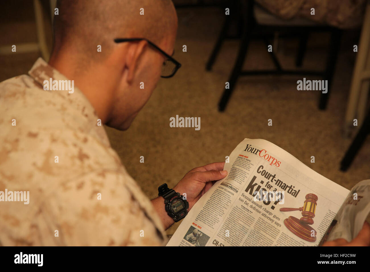 A Marine with the 11th Marine Expeditionary Unit reads a newspaper ...