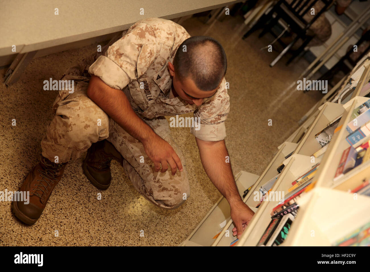 A Marine with the 11th Marine Expeditionary Unit browses the book ...
