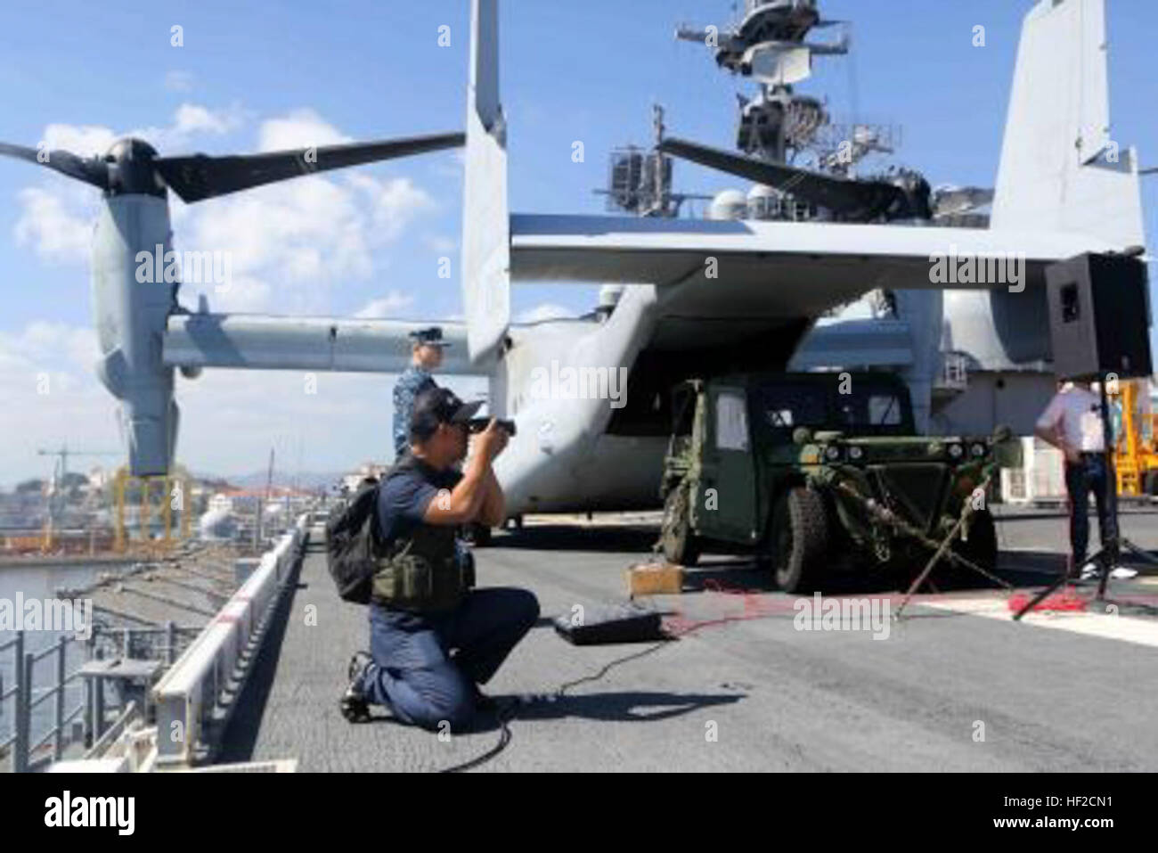 A member of the Brazilian media takes a photo of an MV-22 Osprey aboard ...