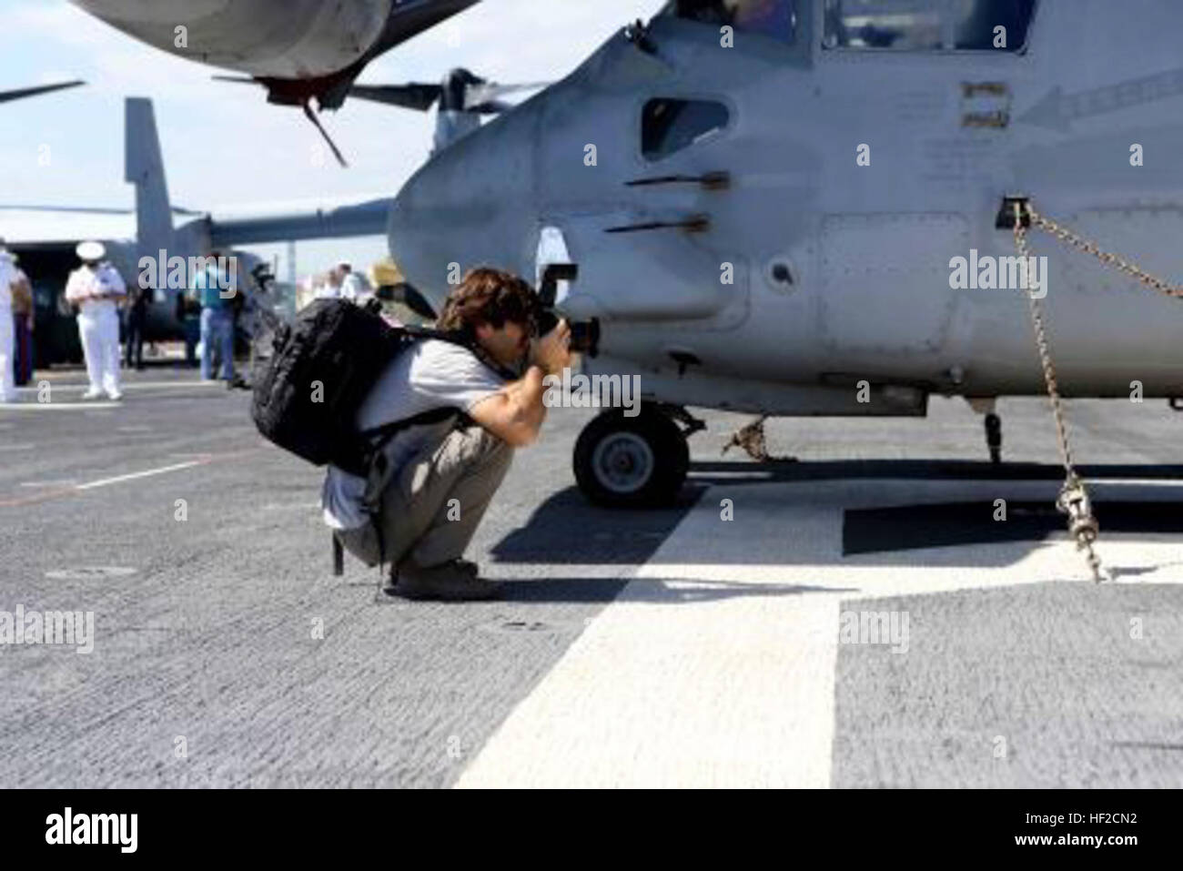 A member of the Brazilian media takes a photo of an MV-22 Osprey aboard ...