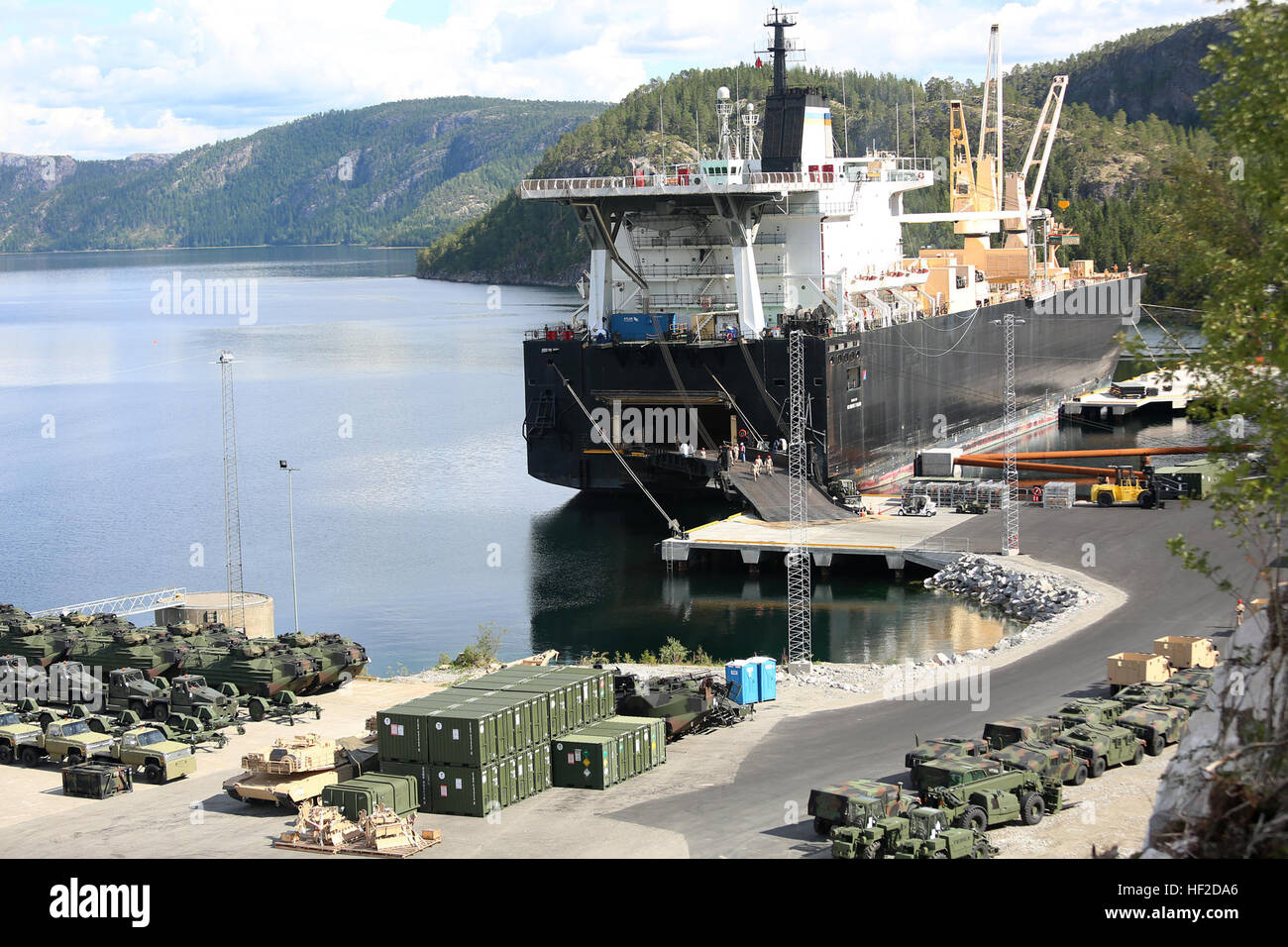 Vehicles and equipment are staged at the designated offload pier during ...