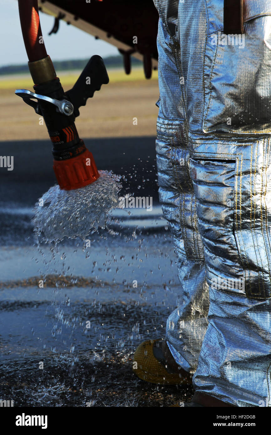 Lance Cpl. Ryan Staats holds a fire hose during Aircraft Rescue and ...