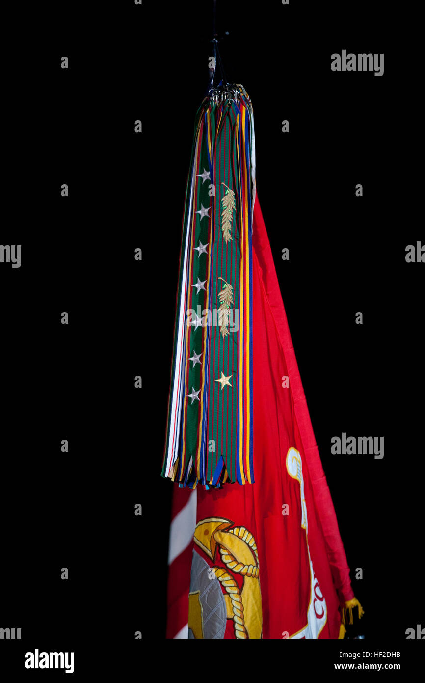 Battle streamers hang from the top of a Marine Corps flag during an ...