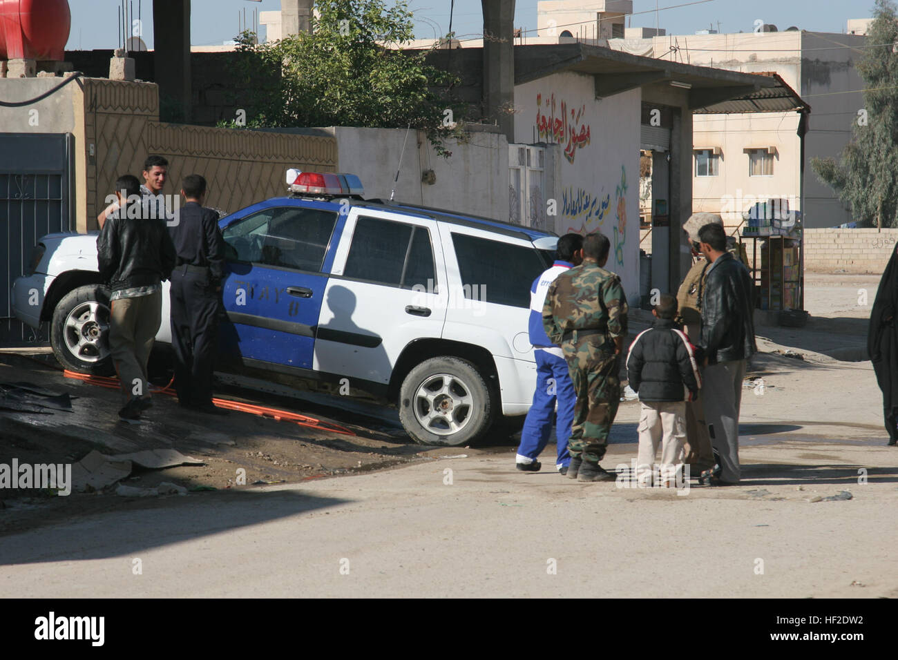 Iraqi police officers talk to Iraqi citizens as U.S. Marines with ...