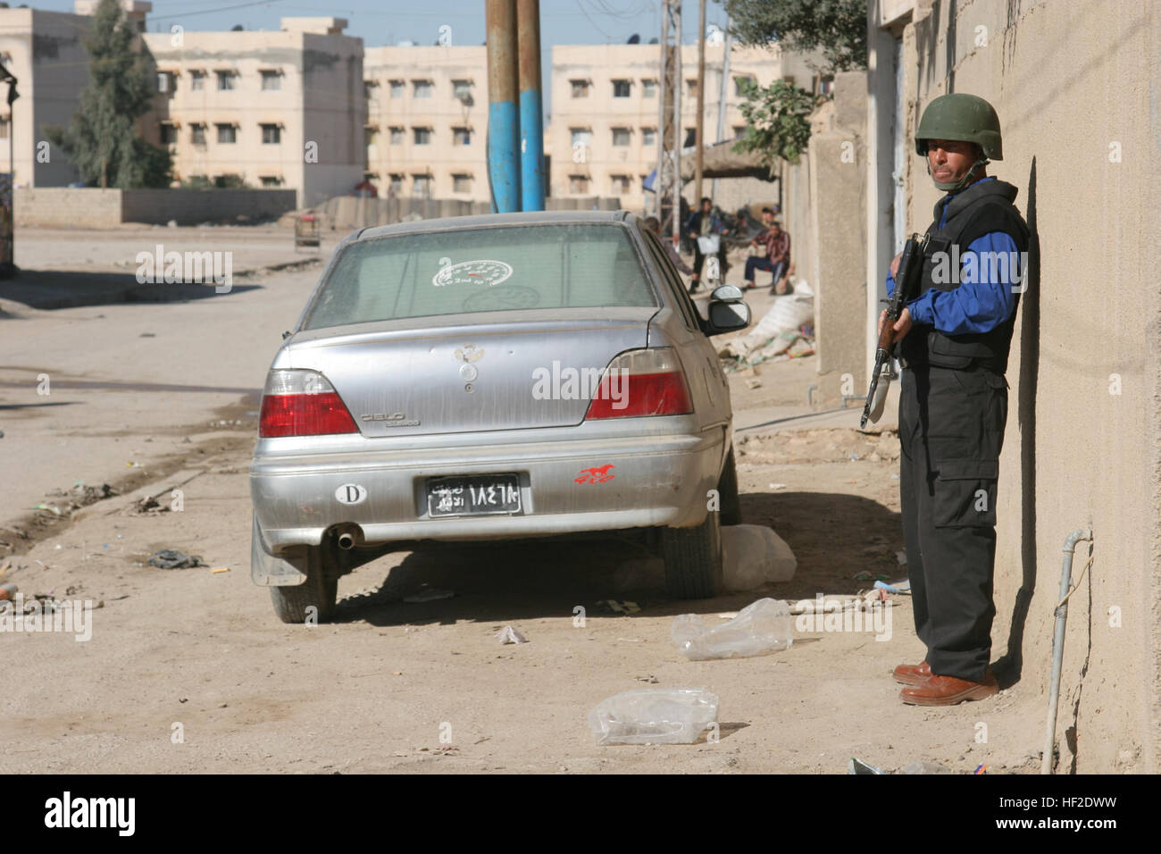 An Iraqi police officer provides security as U.S. Marines (not shown ...