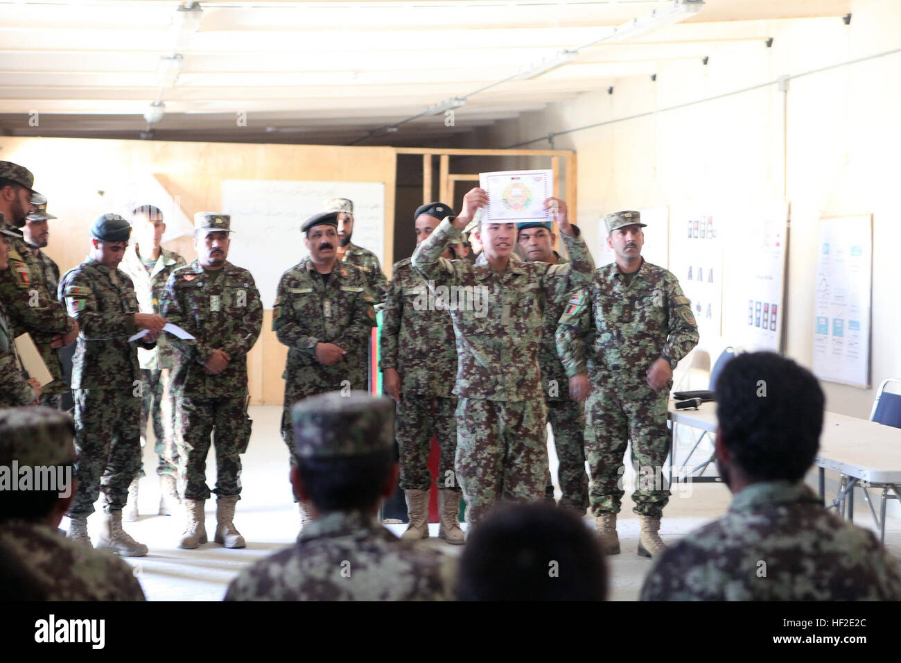 An Afghan National Army soldier with the 215th Corps holds a ...
