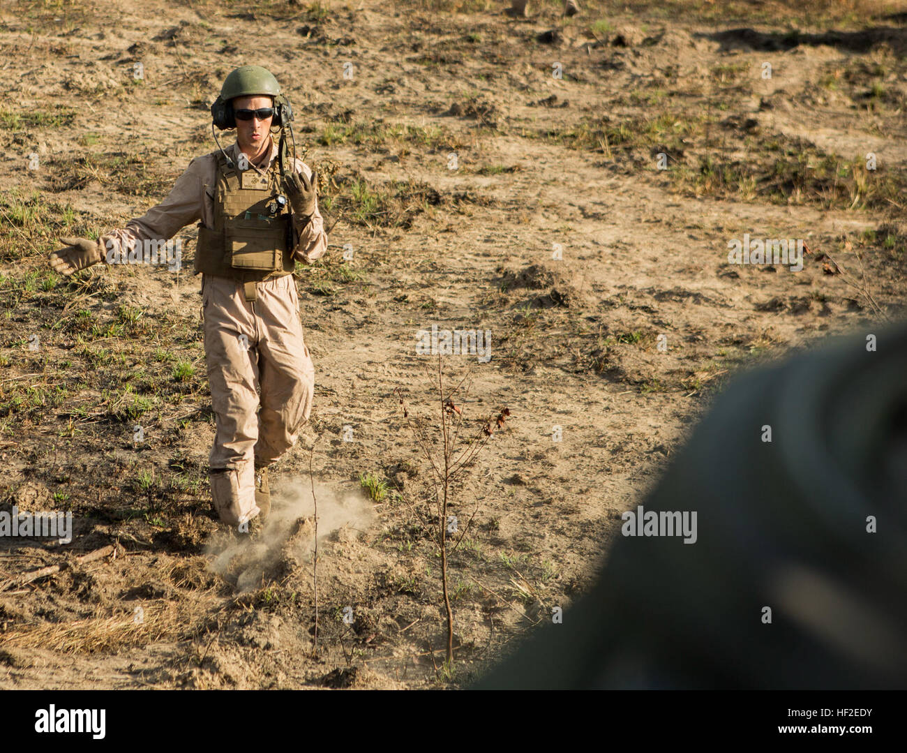 Cpl. Earl Burcham, AAV7A1 tracked vehicle Crew Chief, ground guides an ...