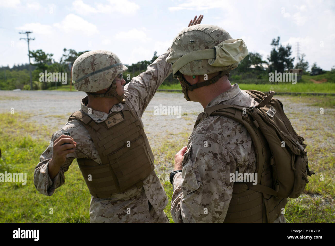 Lance Cpl. Eric Basora, left, prepares to throw an M69 training grenade ...