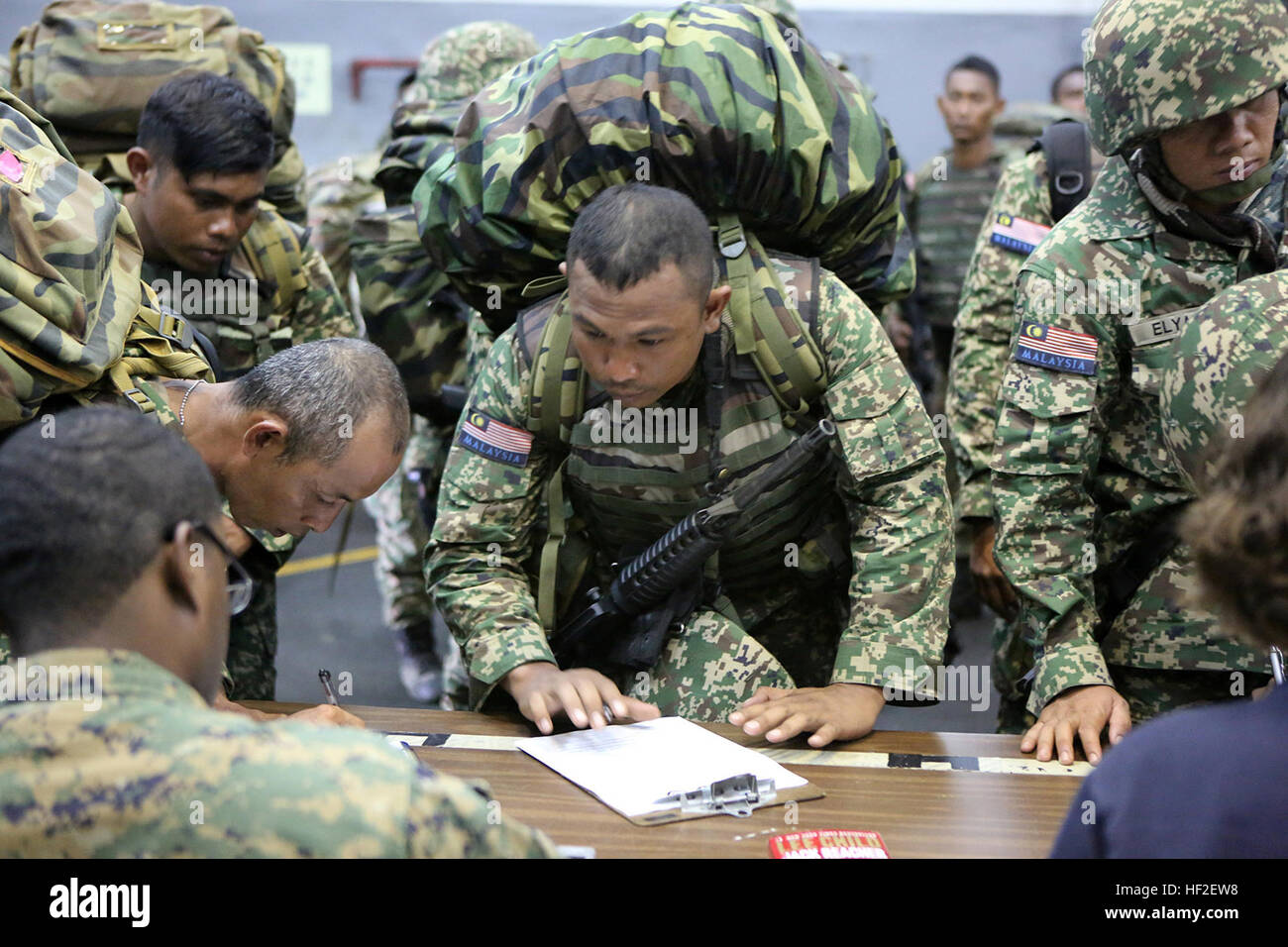 Members of the Malaysian Armed Forces check in with a medical team from ...