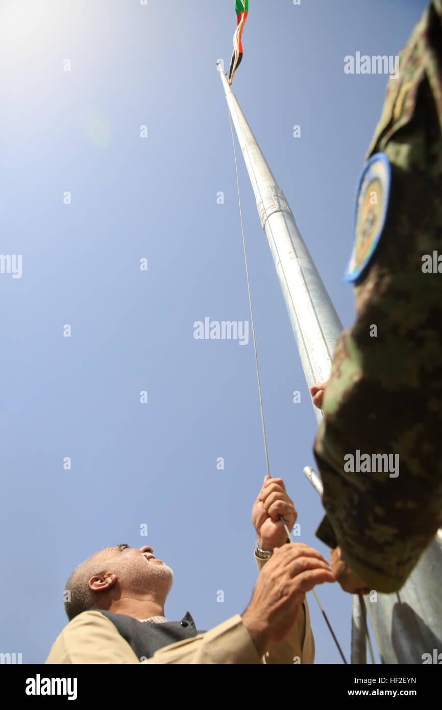 Naeem Baloch, the governor of Helmand province, raises the Afghan flag ...