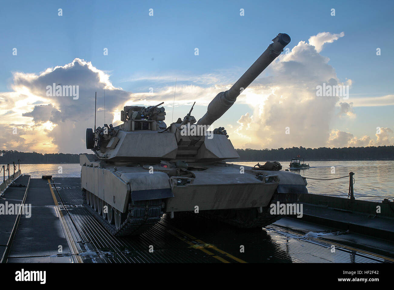 An M1A1 Abrams tank sits on an M17 floating raft, which is used to ...