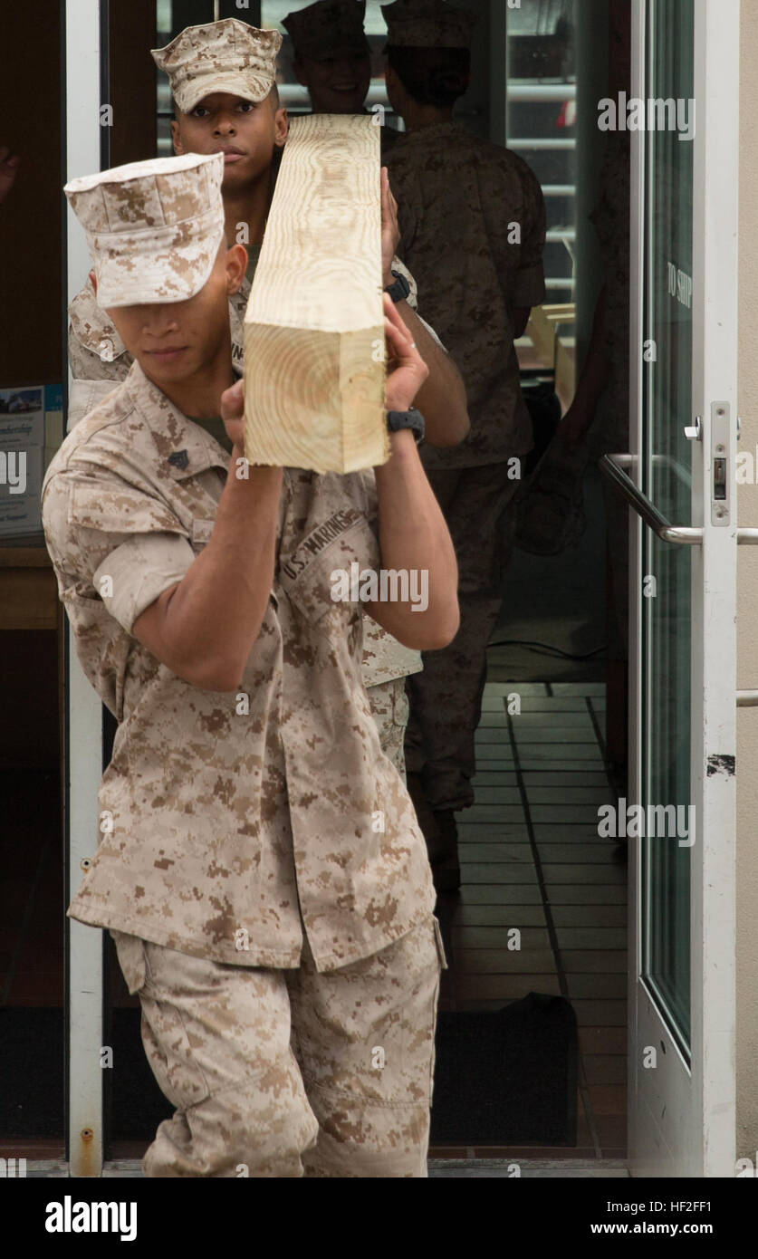 Two Marines help carry timber aboard the USS Constellation in Baltimore ...