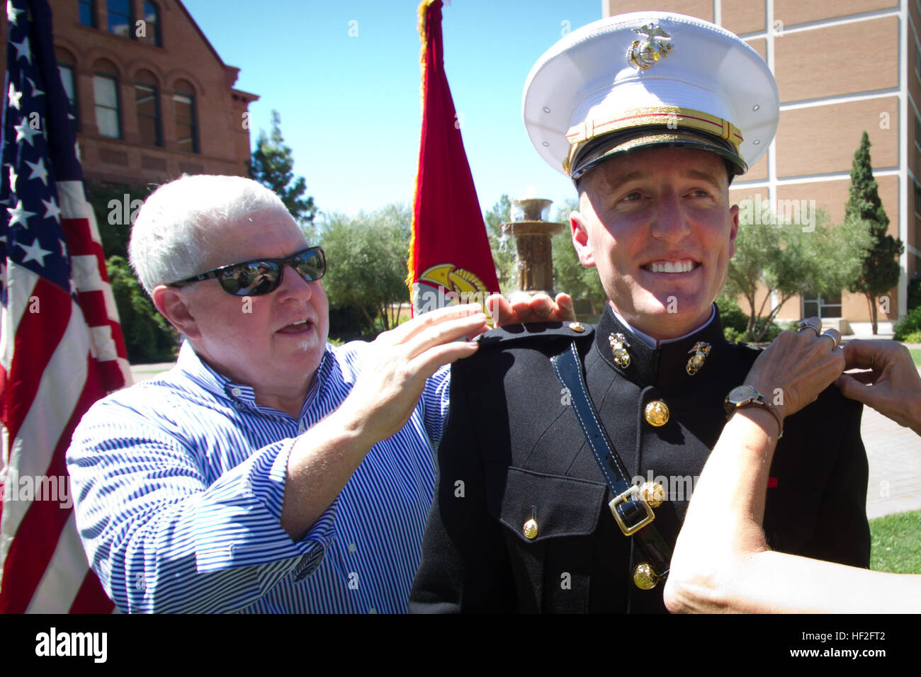 The parents of Colin R. Caskey pin rank insignias on their son, a newly ...