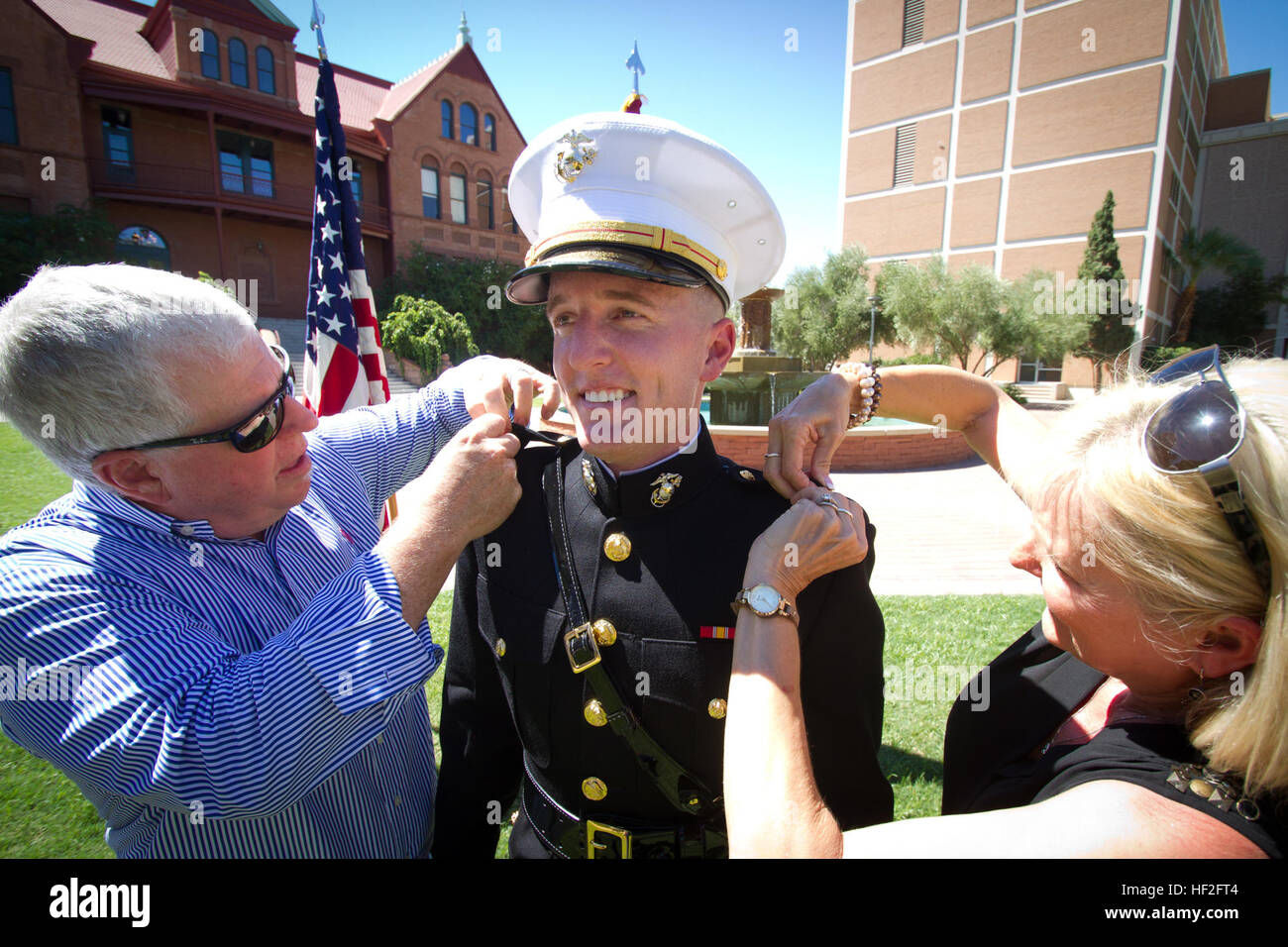 The parents of Colin R. Caskey pin rank insignias on their son, a newly ...