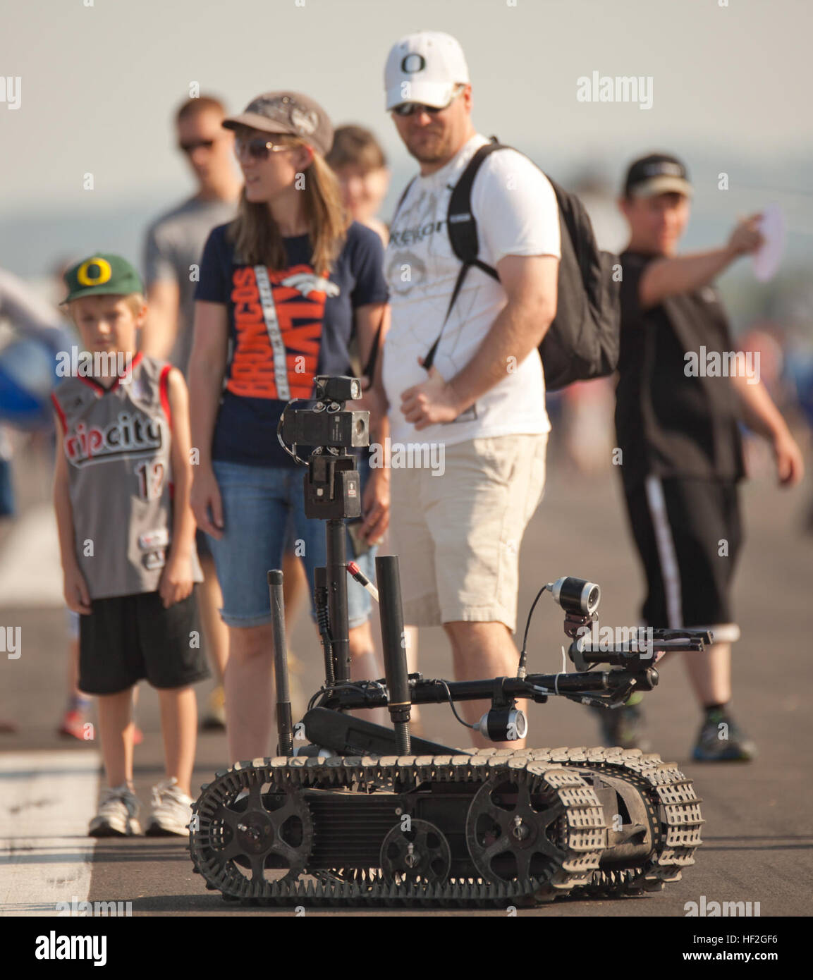 Spectators crowd around the Explosive Ordnance Disposal Robot aboard ...