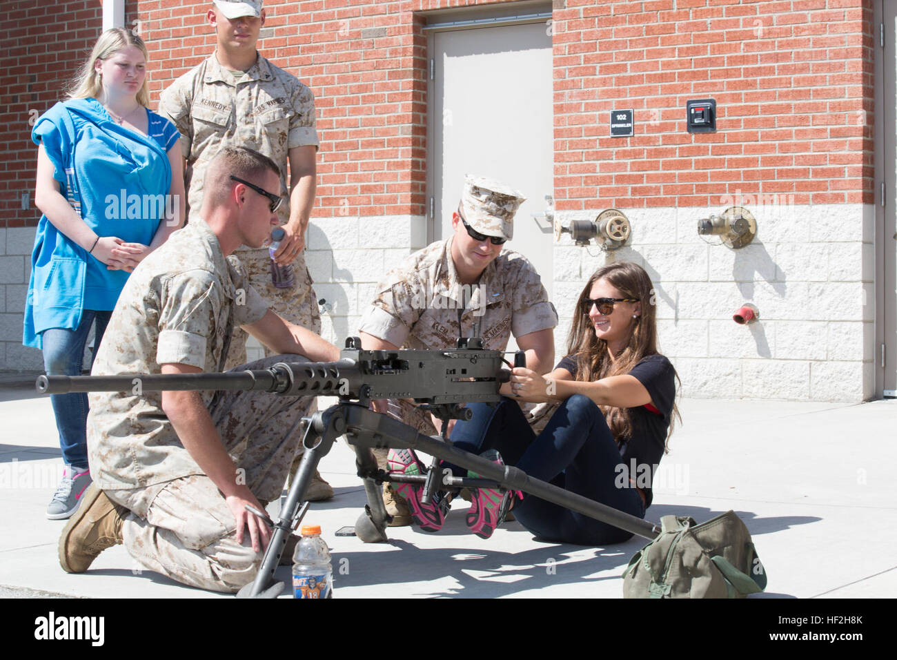Michelle A. Soloff, right, learns about the proper handling of a M2 .50 ...