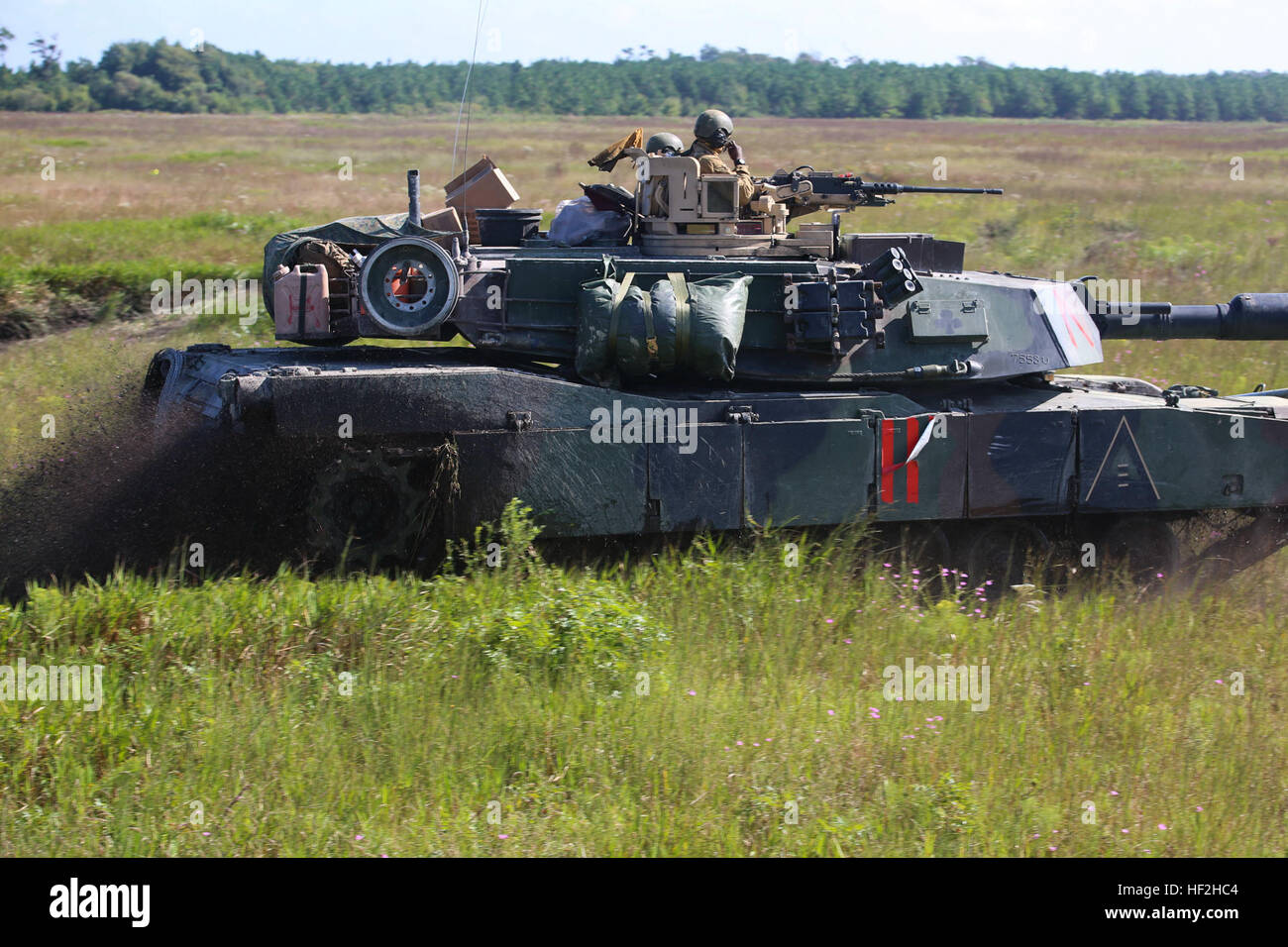 A Marine Corps tank from Alpha Company moves through a muddy training ...