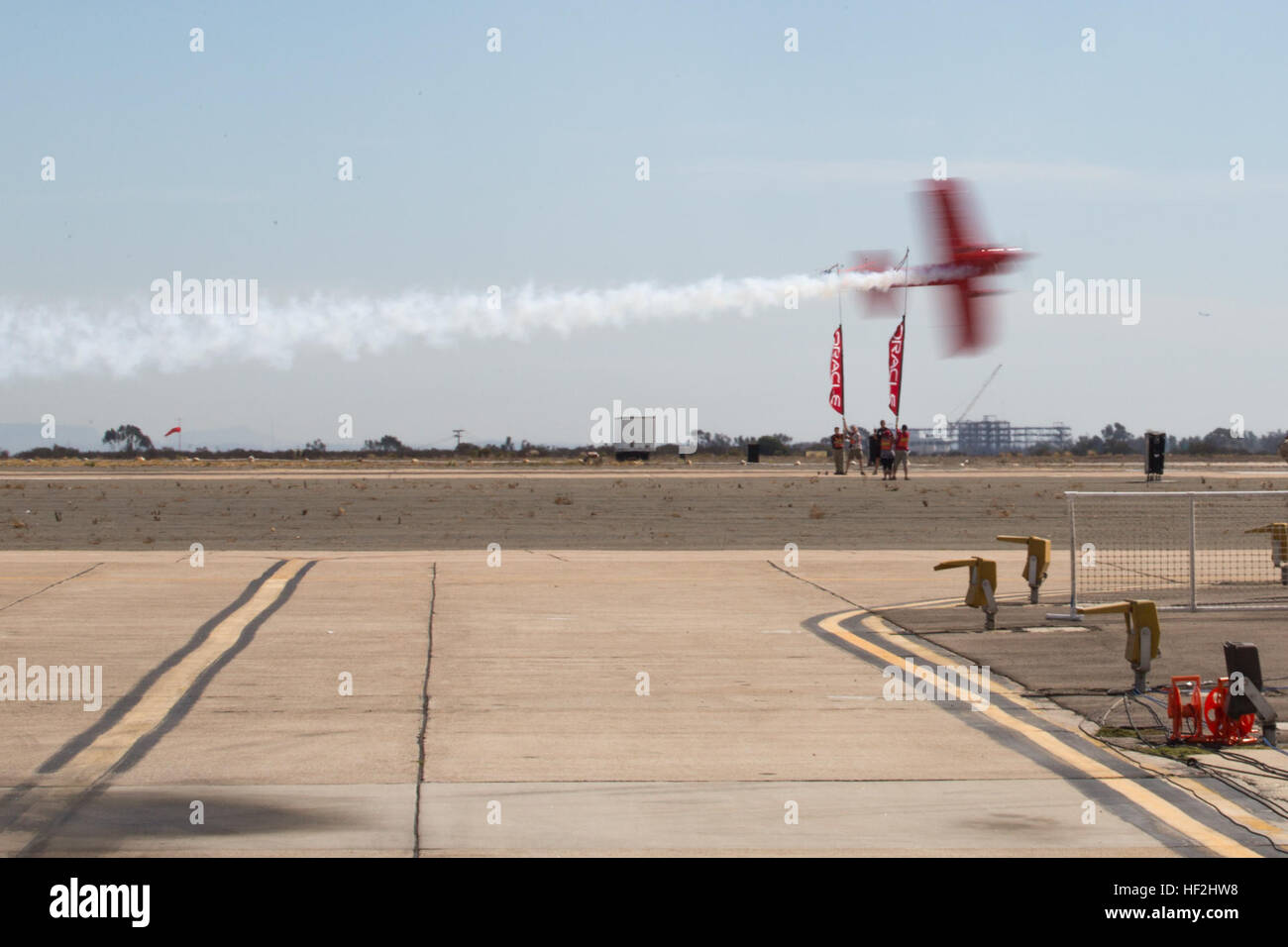 Sean Tucker, Oracle Challenger pilot, cuts a ribbon during one of his ...