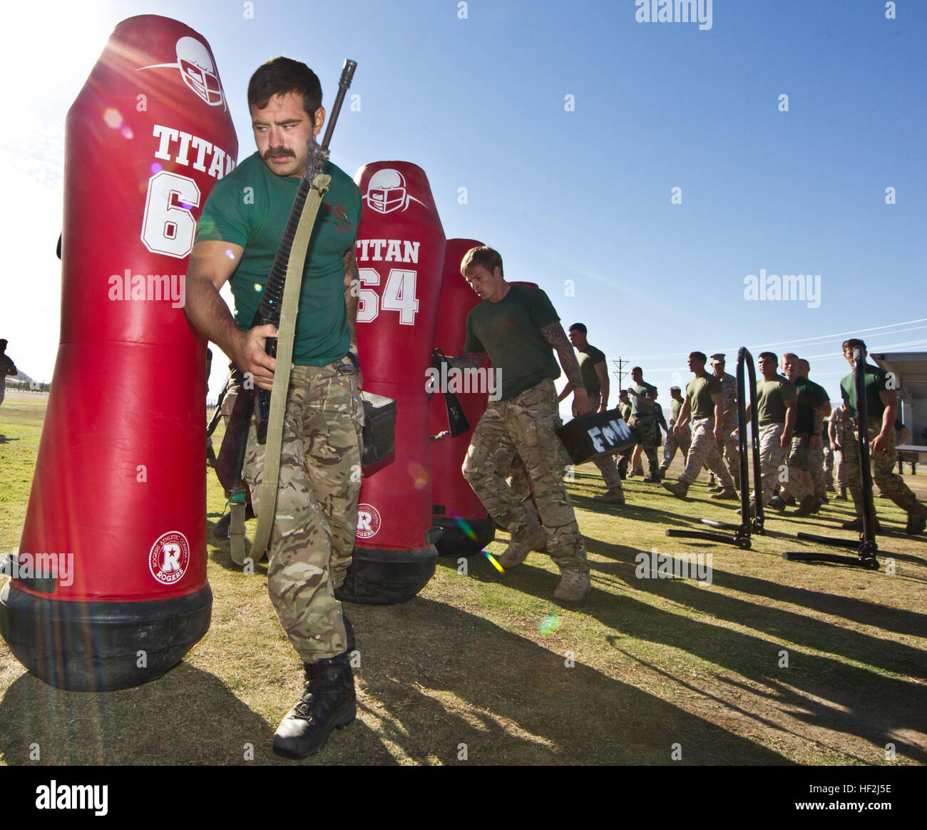 Members of the British Royal Marines maneuver through an obstacle ...