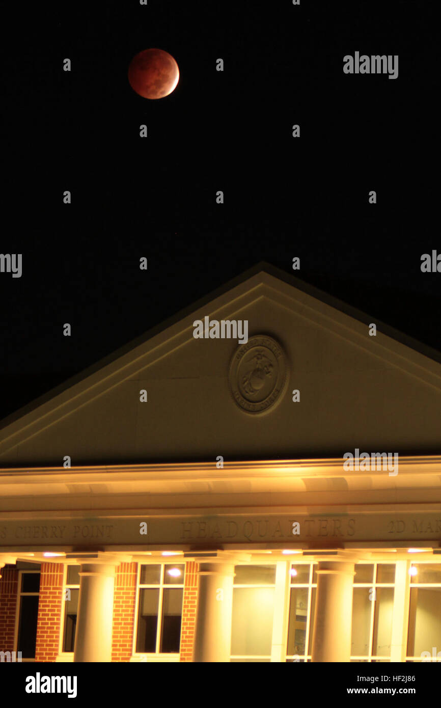 The moon sits in full lunar eclipse over the headquarters of Marine ...