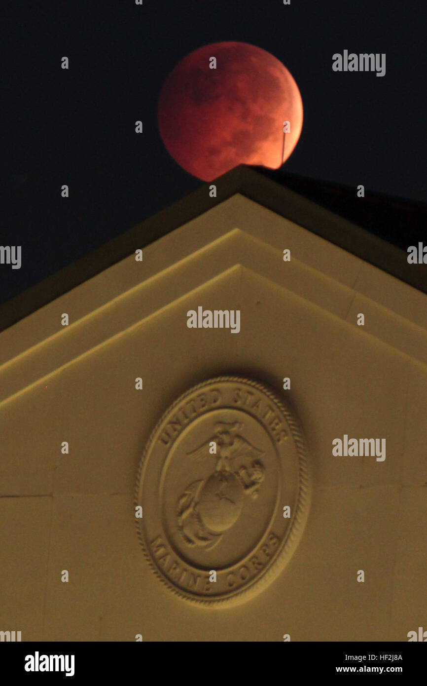 The moon sits in full lunar eclipse over the headquarters of Marine ...