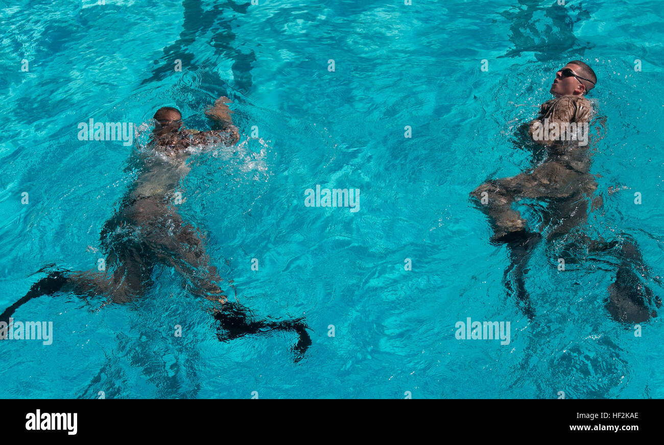 Maj. Breck Perry, left, and Sgt. Christopher Rateau-Holbach swim laps ...