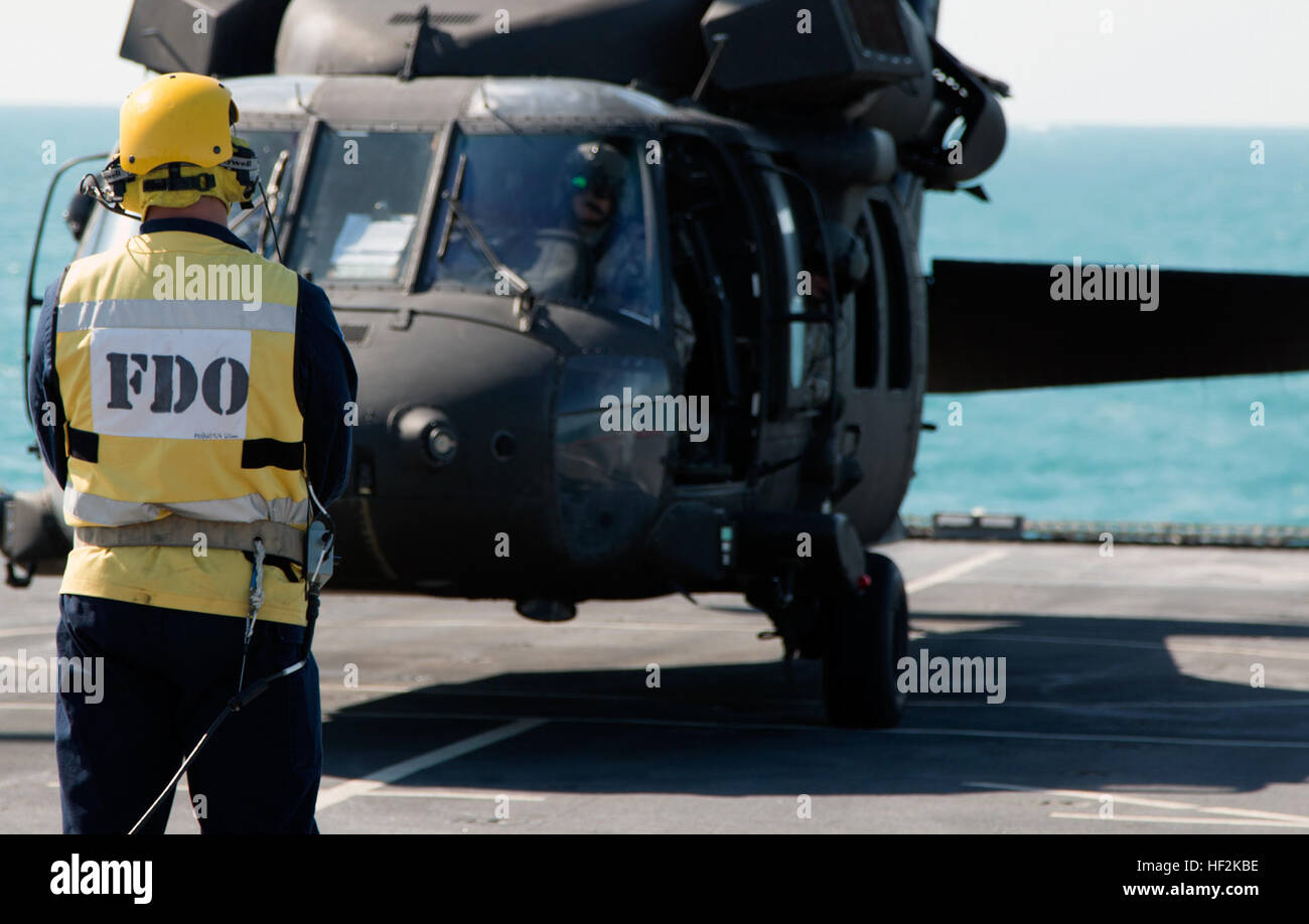 A flight deck officer with the British Royal Navy evaluates the UH-60 ...