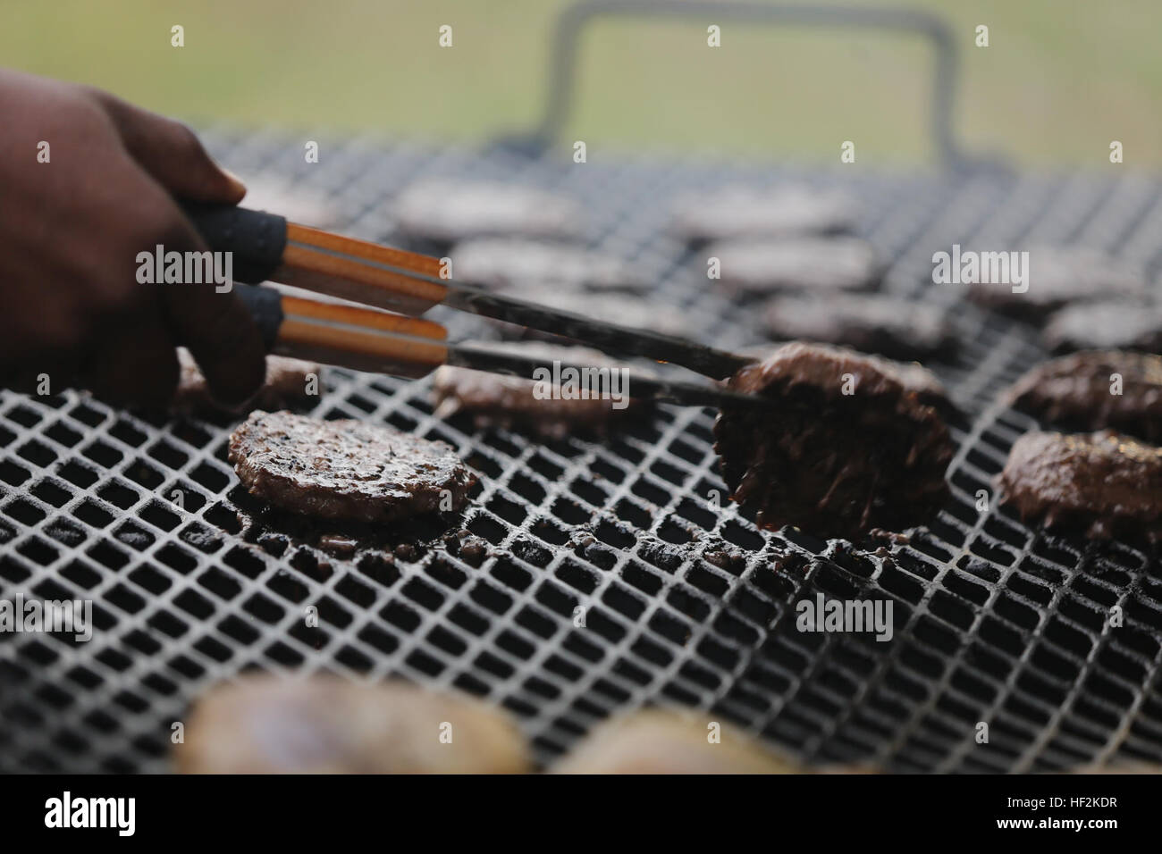Gunnery Sgt. Lorin Coefield Jr. flips a burger during a tailgate ...