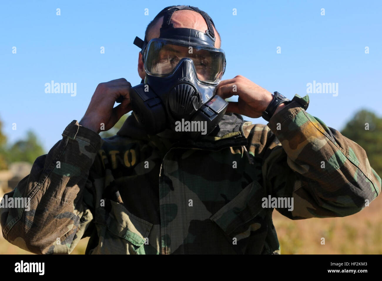 A Marine with 10th Marine Regiment, 2nd Marine Division, dons his gas ...
