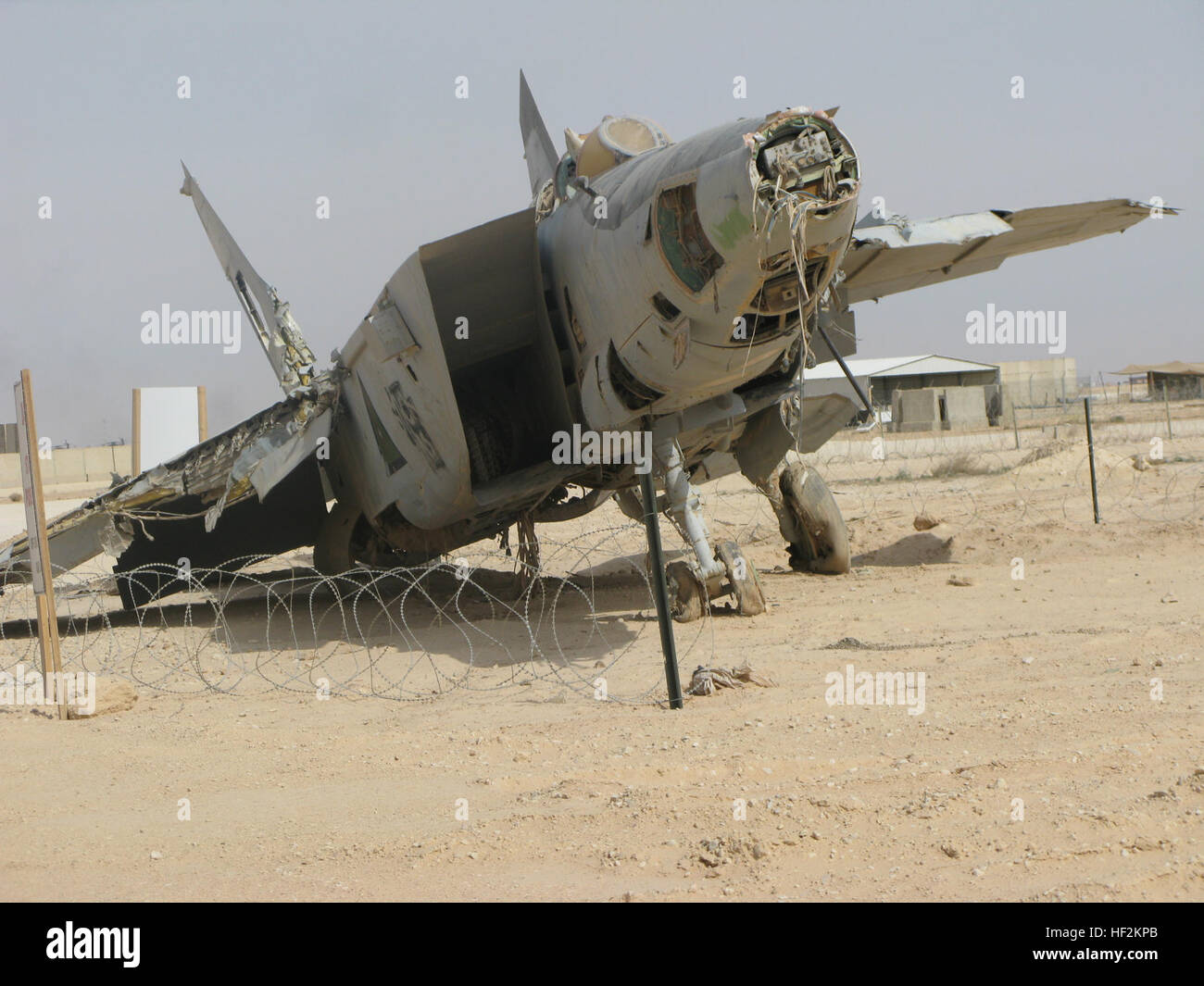 A wrecked MiG-25 aircraft is displayed at Al Asad, showing damage ...
