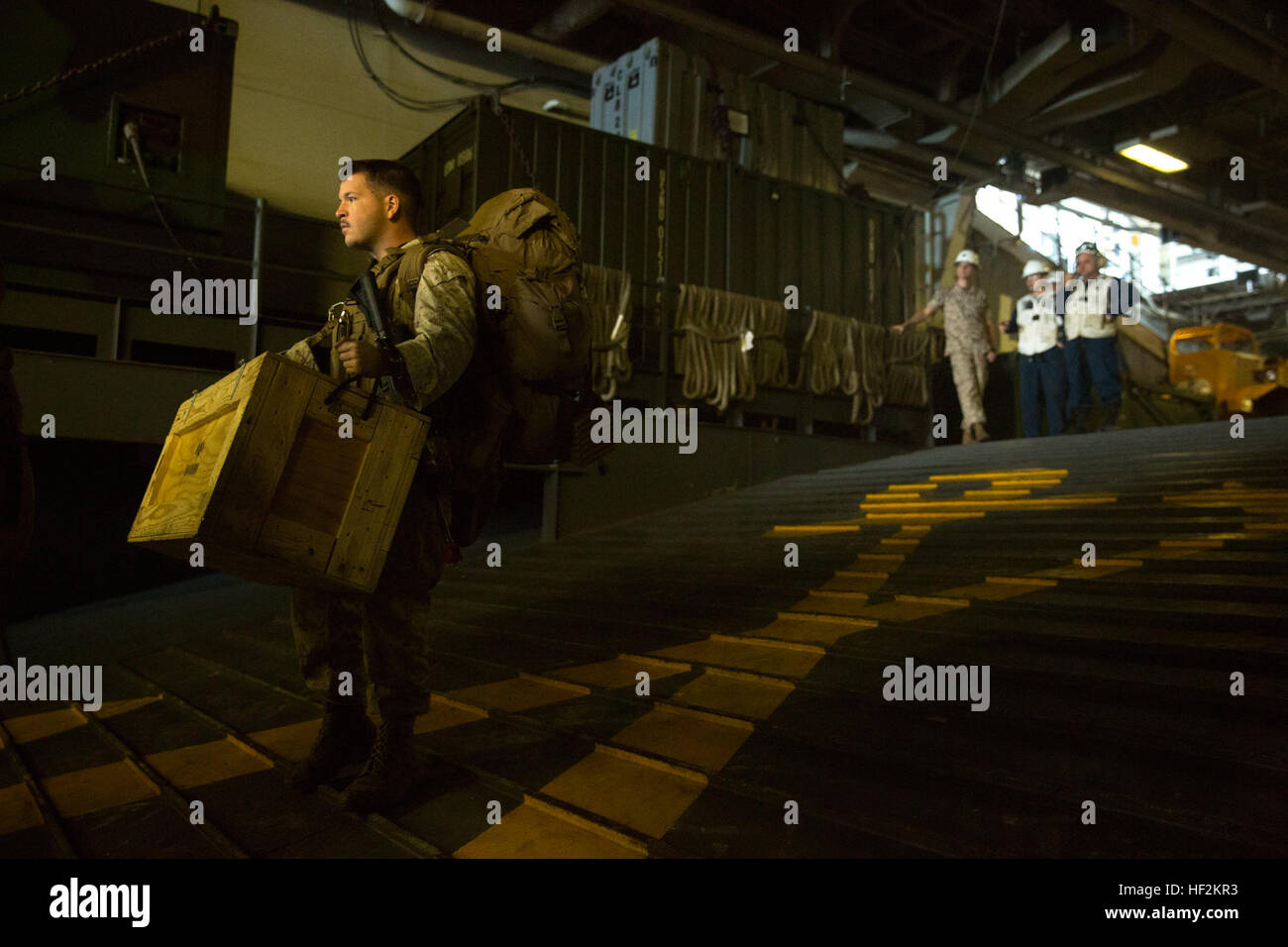 A Marine with the 24th Marine Expeditionary Unit carries gear down the ...
