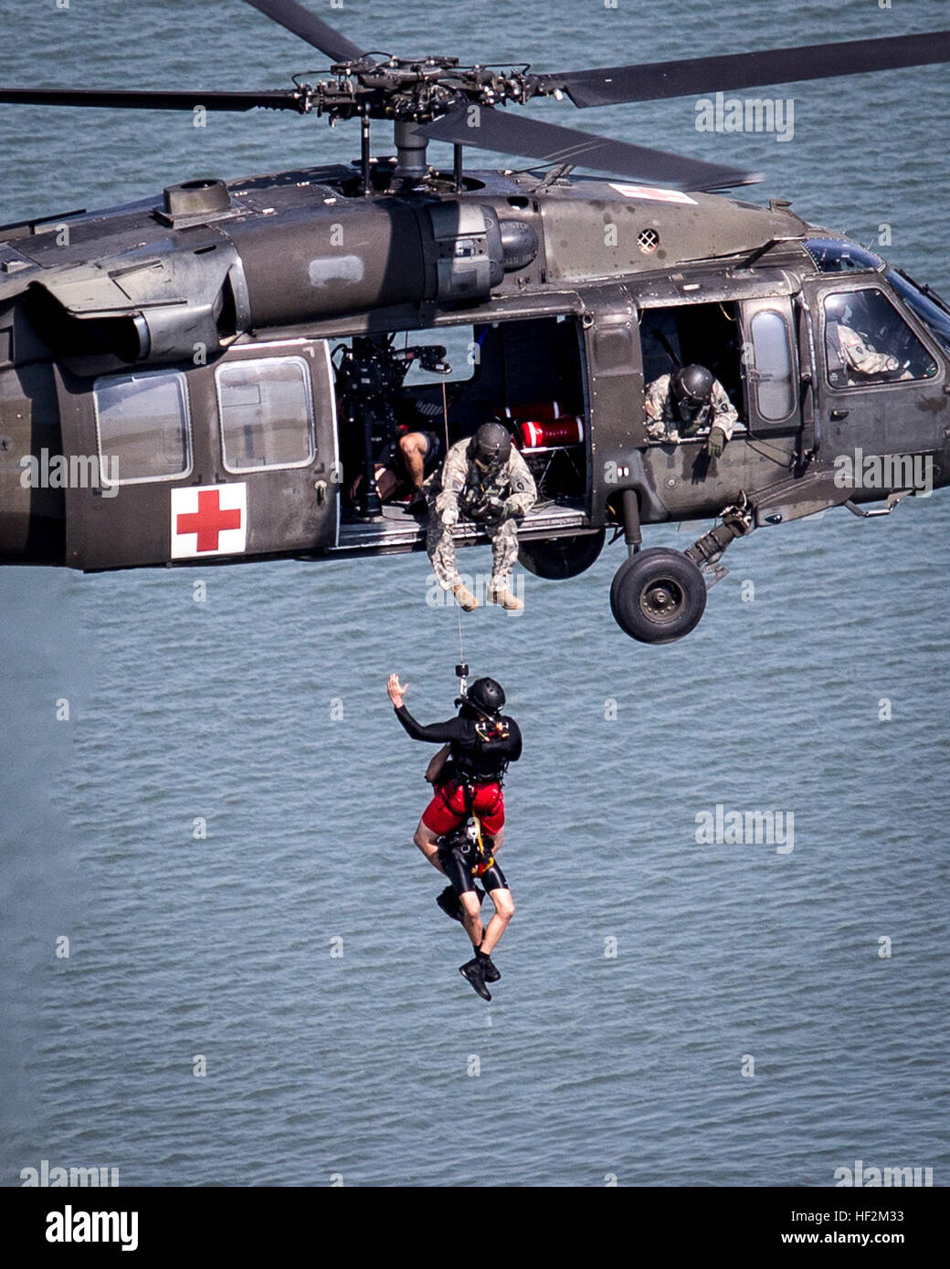 Soldiers hoist members of Texas Task Force 1 (TX-TF1) into their UH-60 ...